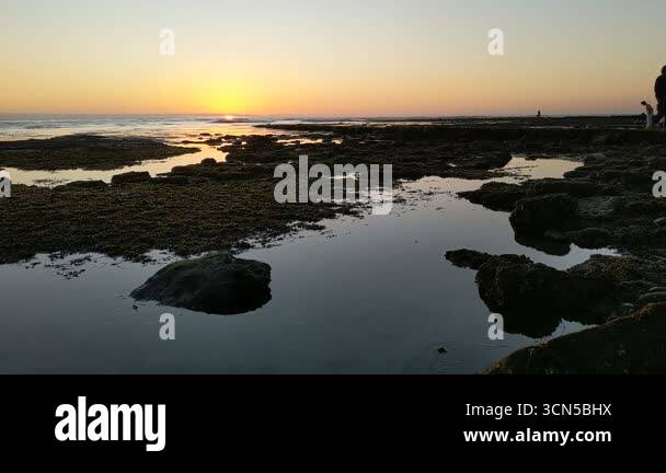 Southern California beach scenes at sunset with tide pools, silhouettes ...