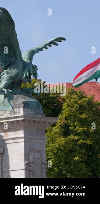 Vertical slow motion of iconic statue with the Hungary flag in ...