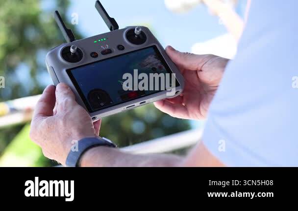 Person controlling drone with remote in Phuket Stock Video Footage - Alamy