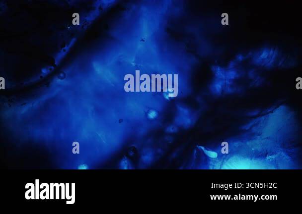 Blue fluid. Paint particles. Defocused neon color water substance drop ...