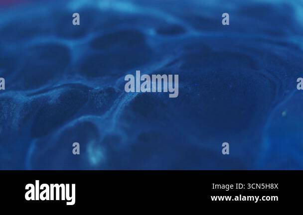 Ripple paint. Shiny fluid. Blur blue color water texture dust chemical ...