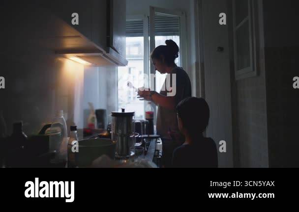 Mother Cooking in Kitchen Beside Open Window While Talking with Child ...