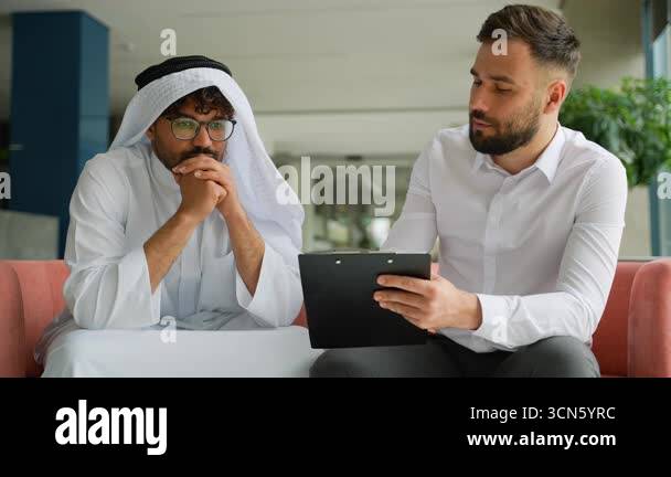 Psychologist actively listening and taking notes while supporting a ...