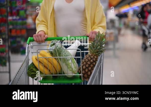 Healthy food purchase at grocery store with customer walking through ...