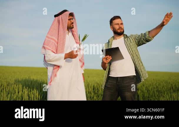 Arab investor and a local farmer are discussing and evaluating the ...