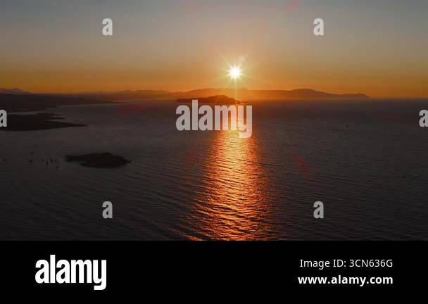 Beautiful aerial view of sunset with the sun descending, golden hues in ...