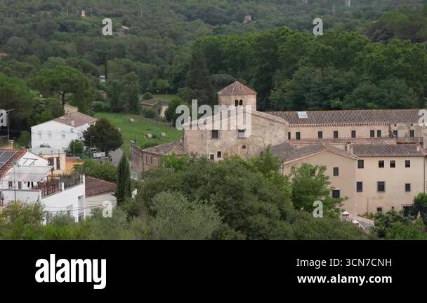 Ancient stone monastery with central bell tower and red clay tiled ...
