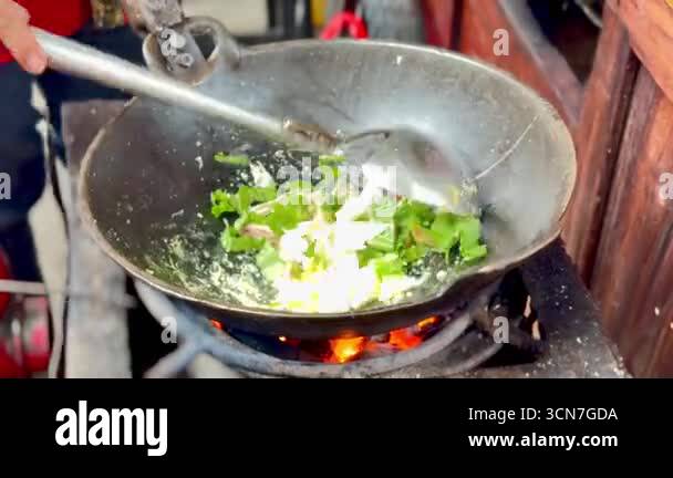 Traditional process of cooking boiling noodles with egg and vegetables ...