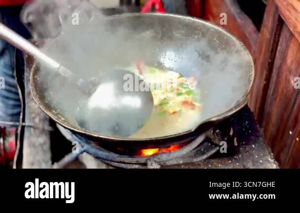 Traditional process of cooking boiling noodles with egg and vegetables ...