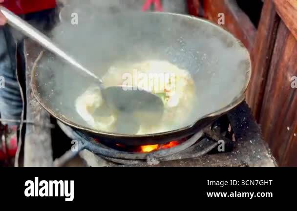 Traditional process of cooking boiling noodles with egg and vegetables ...