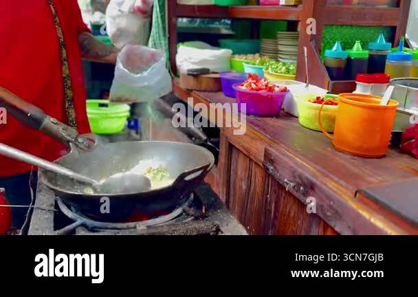 Traditional process of cooking boiling noodles with egg and vegetables ...