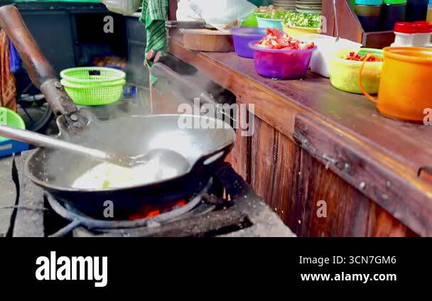 Traditional process of cooking boiling noodles with egg and vegetables ...