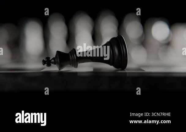 Black king chess piece lies defeated on a sleek marble chessboard ...