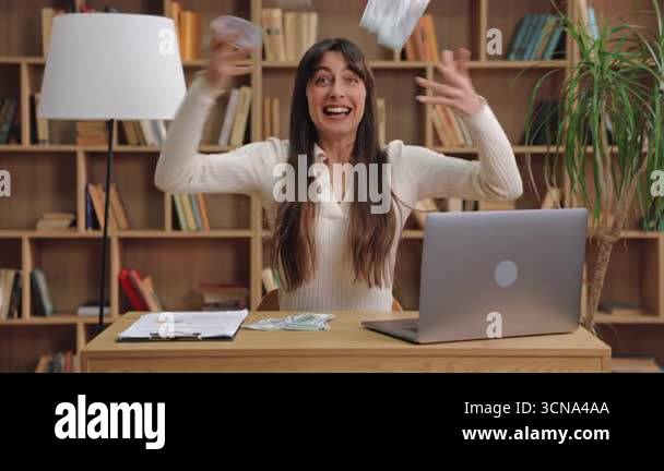 Ecstatic gorgeous Caucasian woman throwing money into air and laughing ...