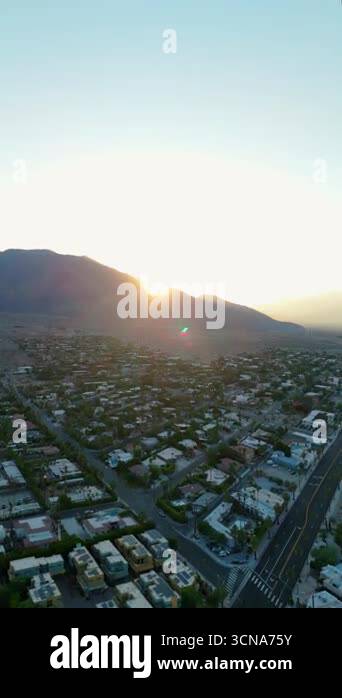 Vertical drone shot capturing the sunrise over Palm Springs, California ...