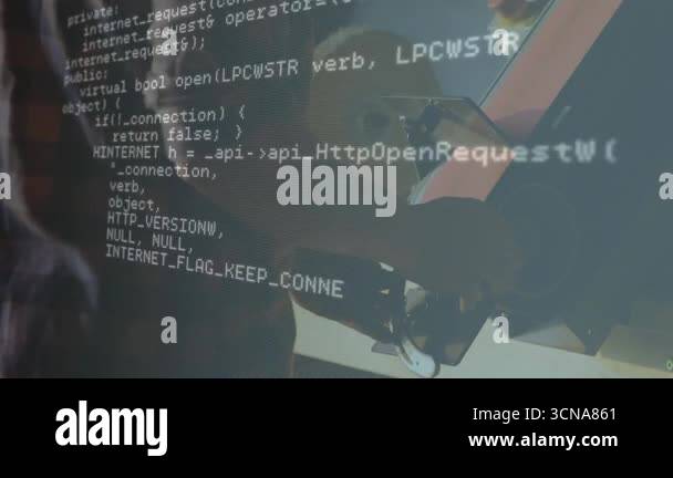Engineer responding to scrolling C++ code overlay in tech lab while ...