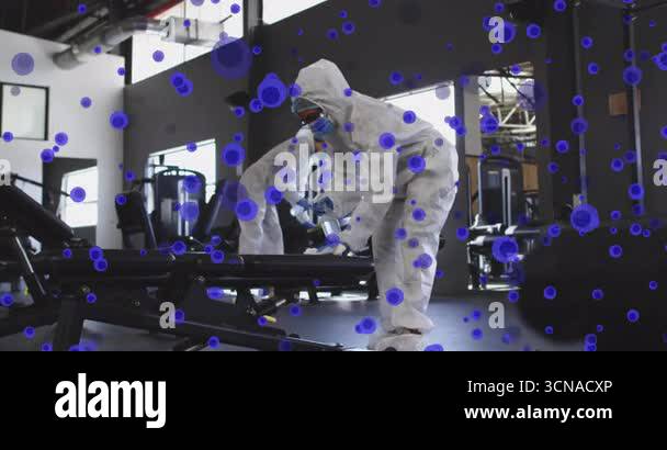 Sanitation worker entering gym bench spraying disinfectant wiping bench ...