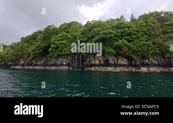 4k footage of a waterfall flowing into the sea on the Isle of Mull ...