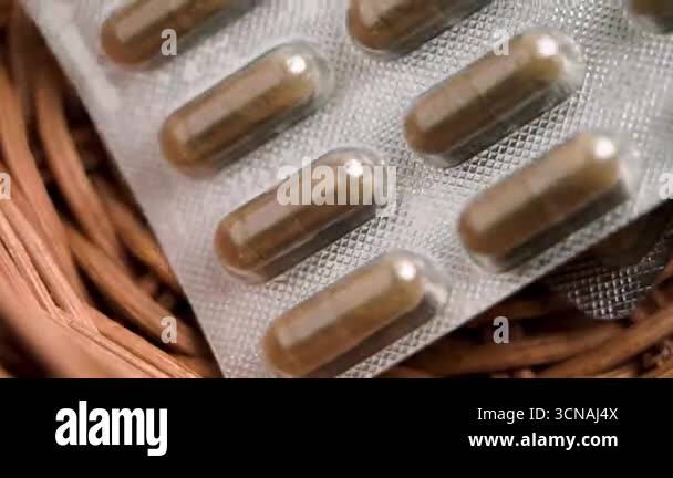 Foil blister pack of pharmaceutical natural herbal capsules falling ...