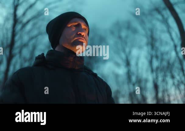 Dramatic portrait of a man with a fearful expression in the forest at ...