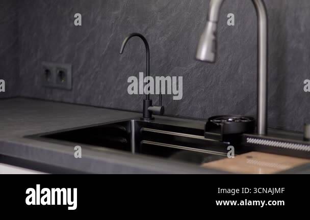A stylish kitchen sink area featuring a contemporary design with a ...