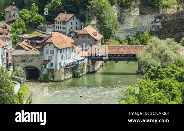 Time lapse, medieval European city. Old wooden covered bridge over the ...