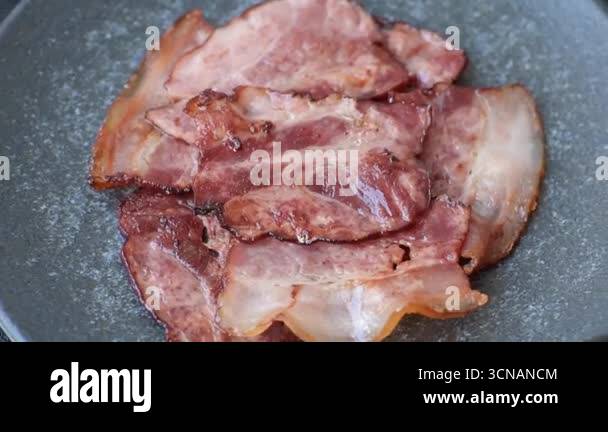 Cooked fried crispy bacon as an ingredient of a delicious English ...