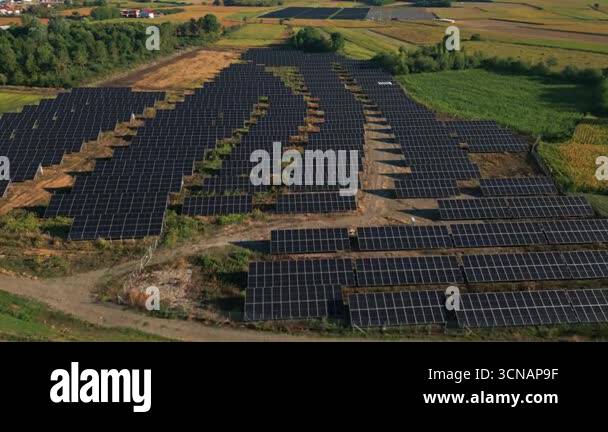 The drone captures the vast expanse of a solar farm, symbolizing the ...