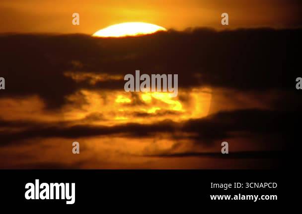 Extreme close-up view of the sun disappearing behind a thick layer of ...