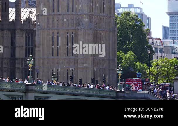 Red bus crossing bridge with pedestrians Stock Video Footage - Alamy