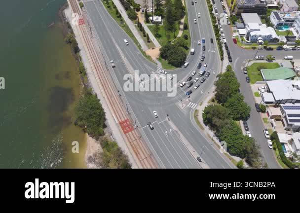 Cars navigating a complex road intersection near water Stock Video ...