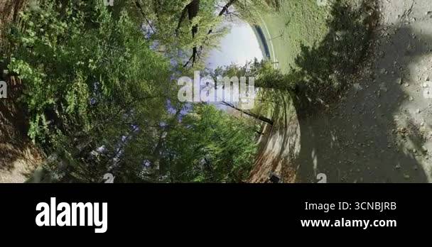 This is a captivating fisheye view of a picturesque park. The video ...