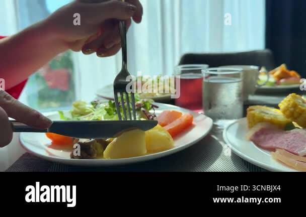 dinner table cut potatoes meat juice water different food on table with ...