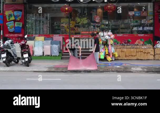 motorcycle passes by the store in real life vietnam danang beach people. vietnam danang 09.04. ...