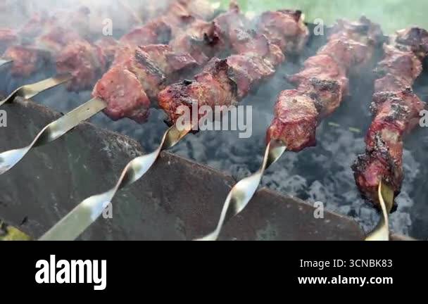 Grilled meat on the grill with open fire. Shashlik, traditional ...