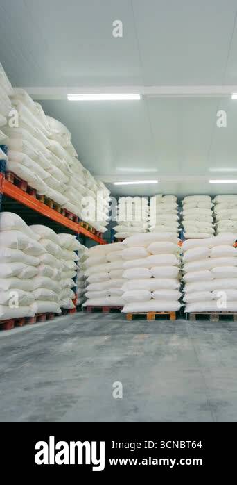 Unloading of large white bags from long-term storage of bulk products ...