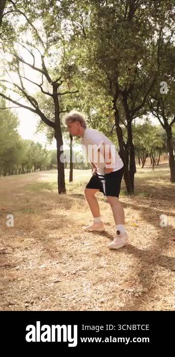 Sporty male stretching leg muscles during outdoor fitness routine ...