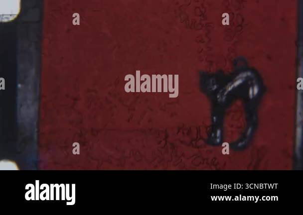 A vintage 8mm stop motion animation frame featuring two stylized black ...