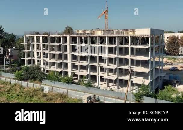 Close Up View Of Unfinished Concrete Building Frame, Workers On Top ...
