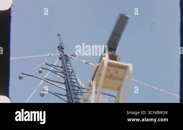 This 8mm film footage from the 1970s captures a low-angle view of retro ...