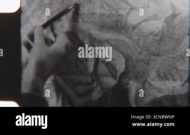 8mm film footage of a hand tracing a route on a paper map with a pen ...