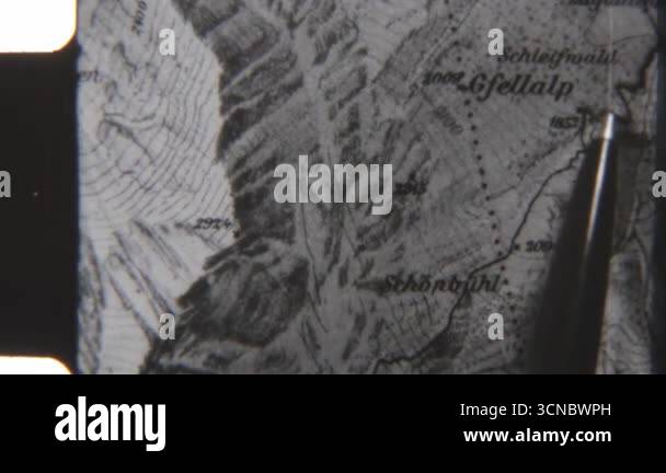 8mm film footage showing a pen tracing a path on a mountain topographic ...