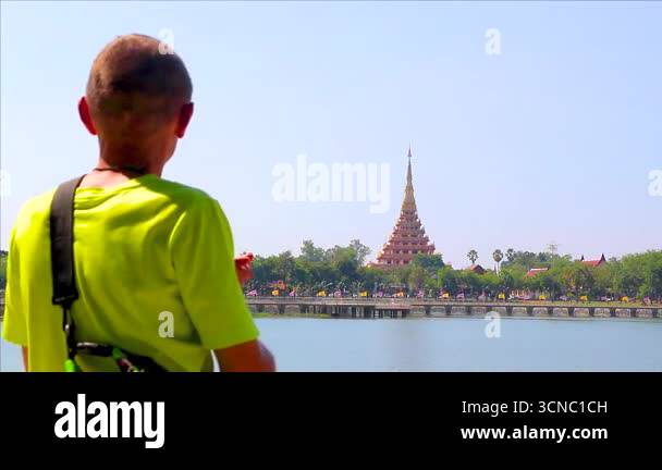 Handsome male tourist man at the Phra Mahathat Kaen Nakhon pagoda style ...