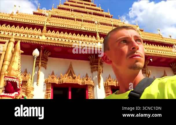 Handsome male tourist man at the Phra Mahathat Kaen Nakhon pagoda style ...