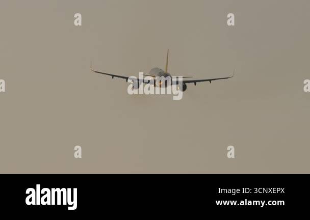 Rear view of a jet airliner with generic livery departing the runway ...