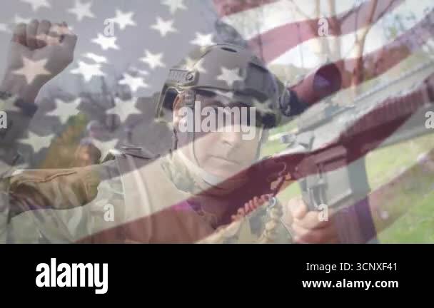 Soldier kneeling in field raising fist initiating military advance as ...