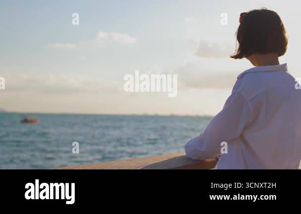 girl taking picture of ship standing on embankment. Beautiful female ...