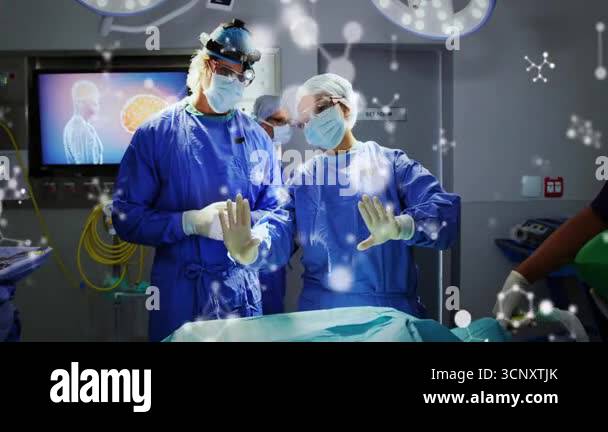 Two surgeons raising and navigating AR holograms while assistant ...