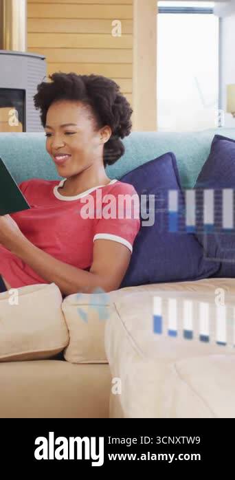 Reading book on couch, woman with data processing animation over ...