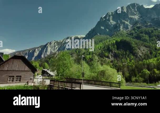 Panoramic view of high Alps on a sunny day, starting with a wooden ...